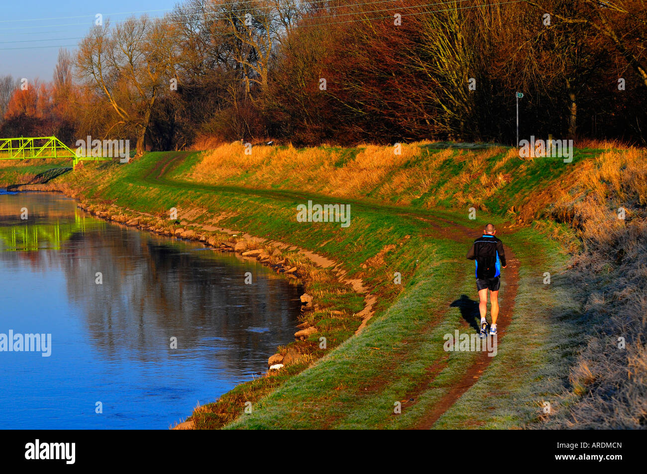 jogger running by river mersey Stock Photo - Alamy
