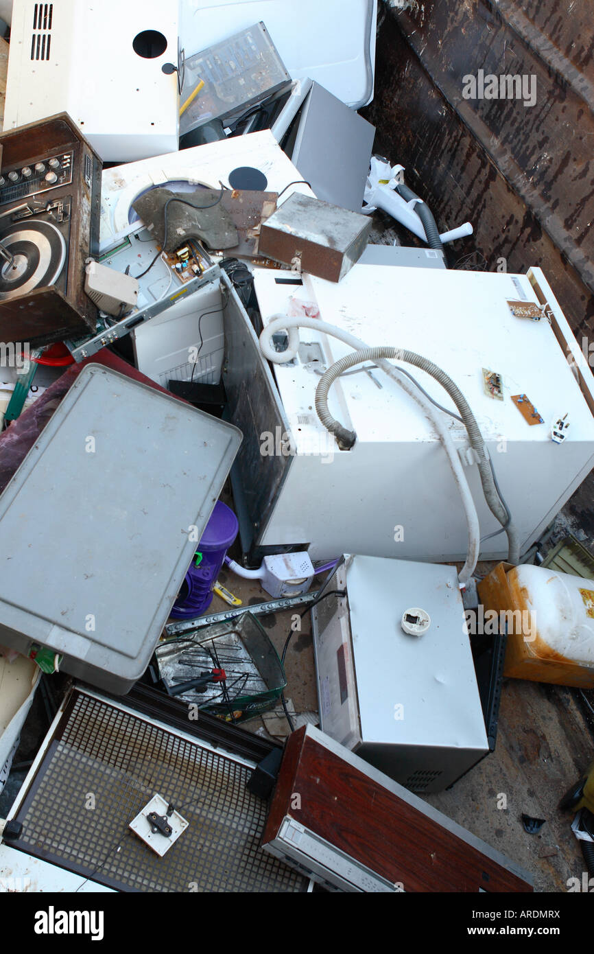 Recycling old waste metal products being collected in a skip at a local ...