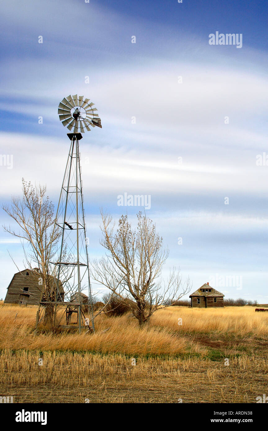 An old windmill towers over an abandoned farm in Southern Alberta Stock ...