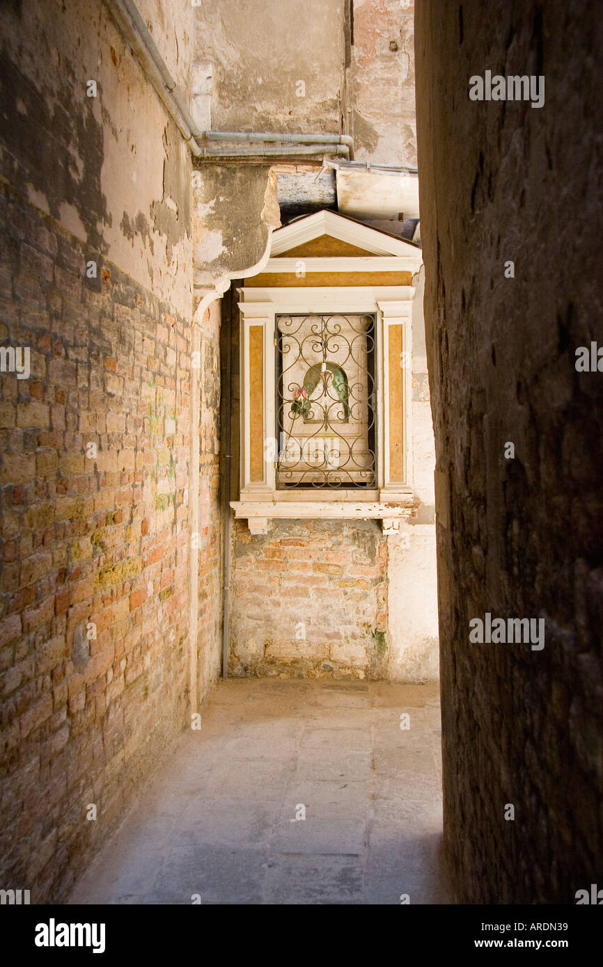 Shrine to Mary in corner of wall alcove in portico passageway Venice ...