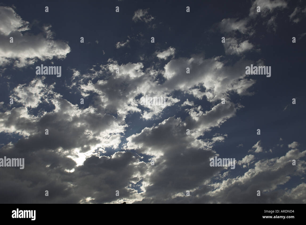 clouds gather at sunset throwing shadows and lights across the skies ...