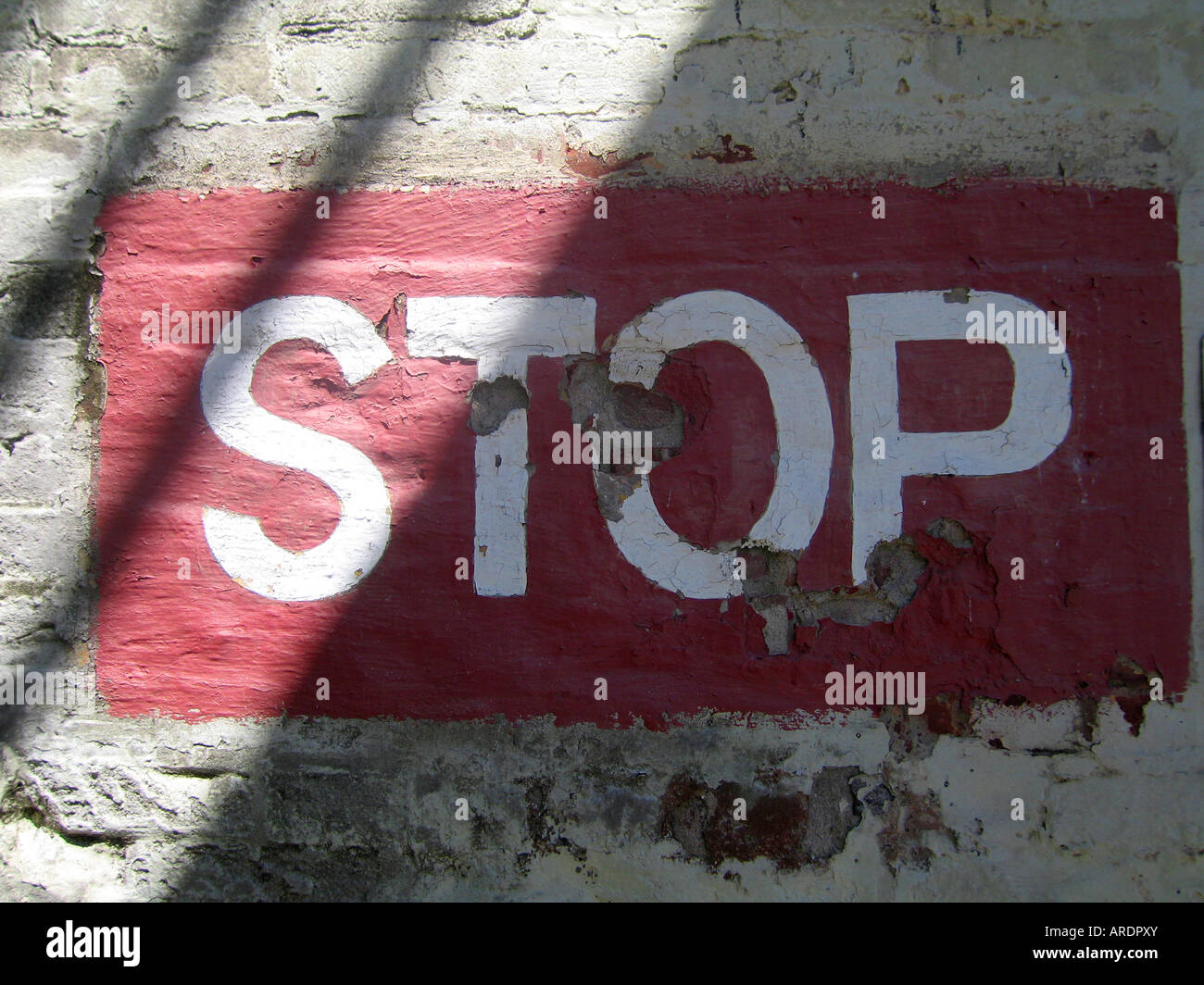 Stop sign on Alcatraz prison wall with ray of sunlight, San Francisco ...