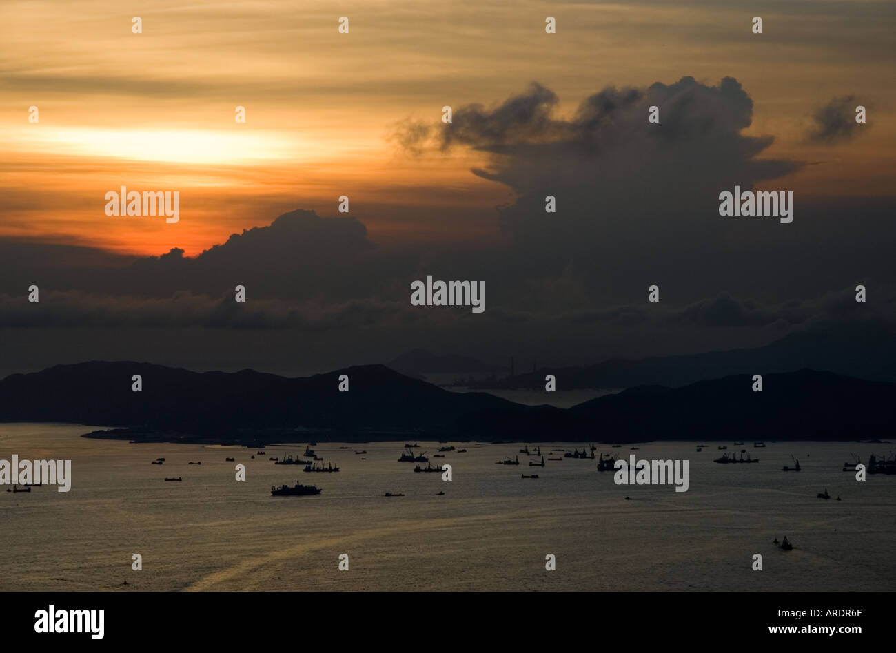 Cargo ships sail through Hong Kong Harbour at sunset Stock Photo - Alamy