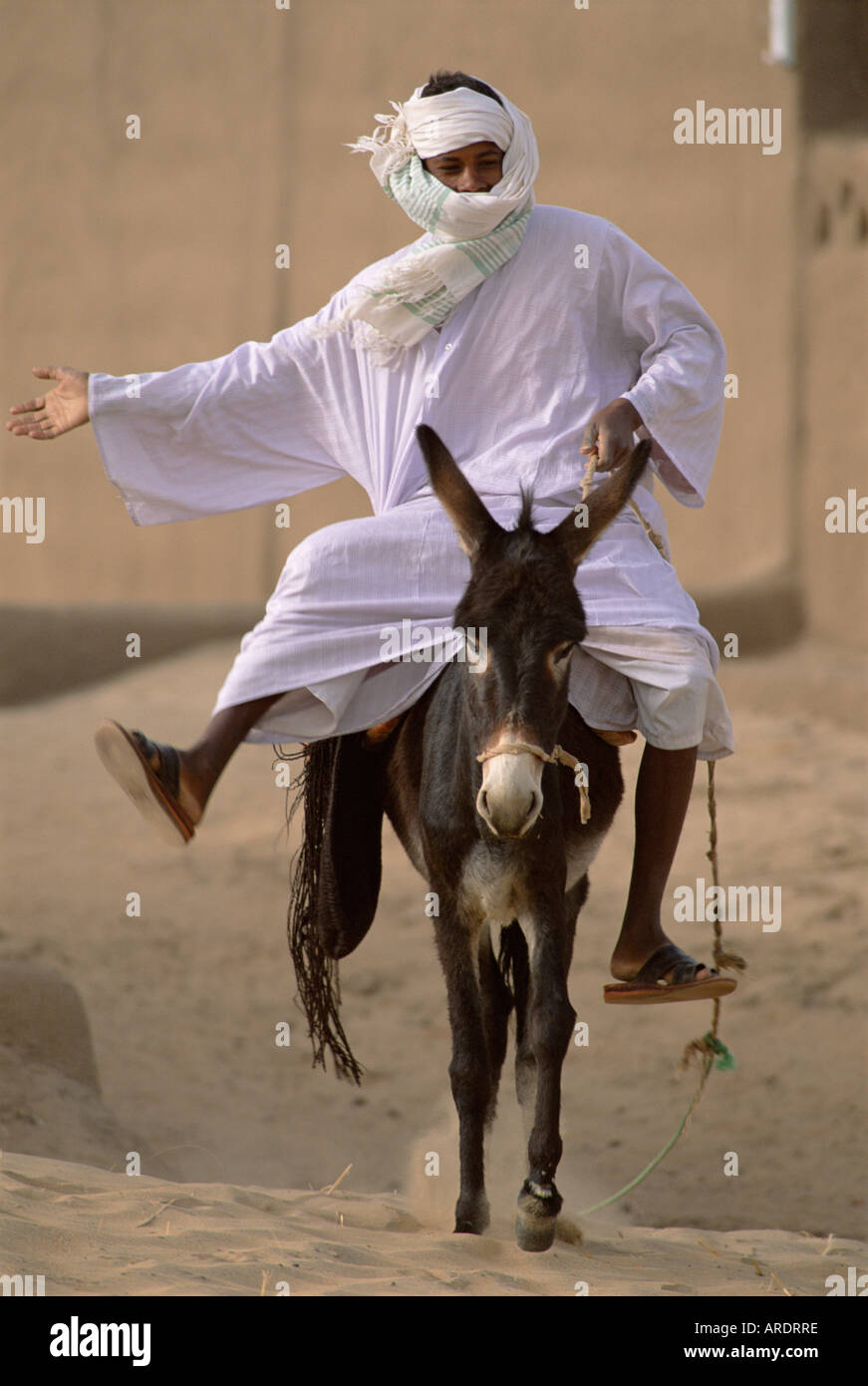 Sudanese man riding donkey Stock Photo - Alamy