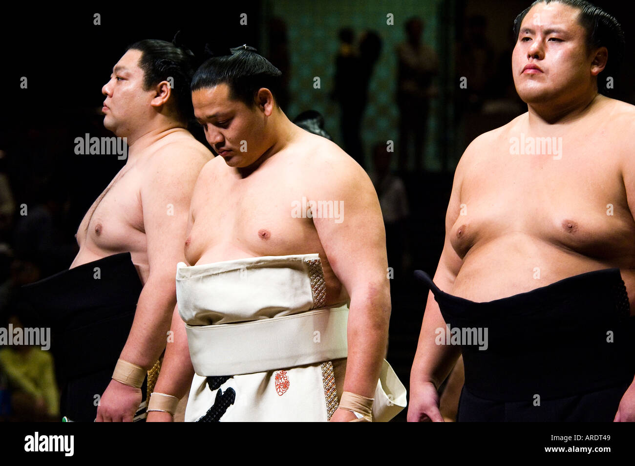 Sumo wrestlers stand for a ceremony at the Ryogoku stadium in Tokyo ...