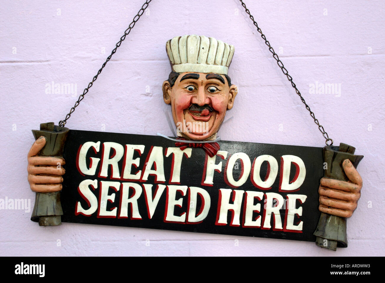 'Great Food Served Here' sign hanging on wall outside cafe in village ...
