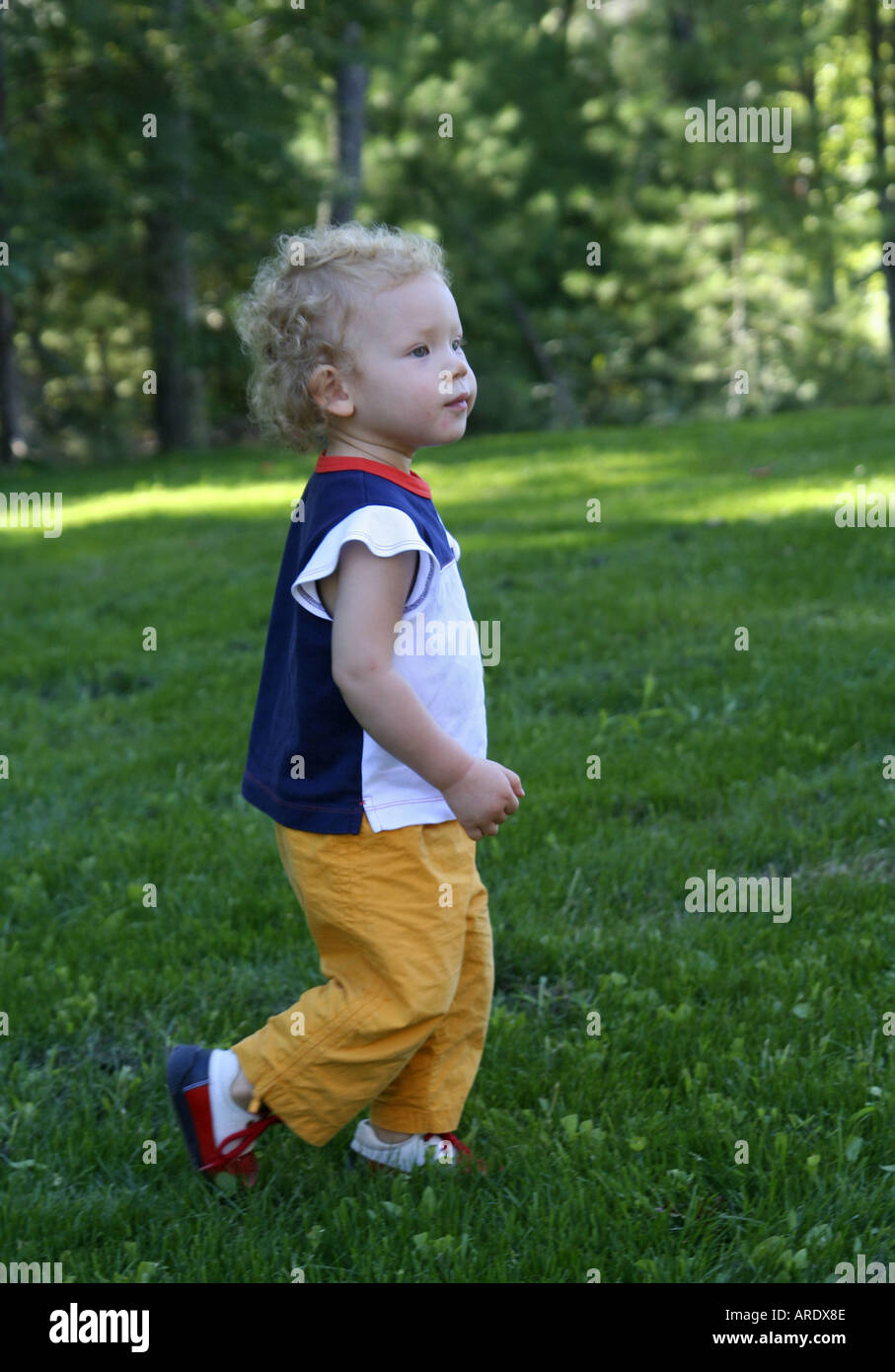 three year old girl playing outdoors Stock Photo - Alamy