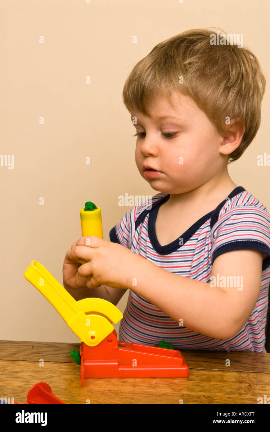 boy toddler child playing with 'Play Dough' tools and toys cutting and ...