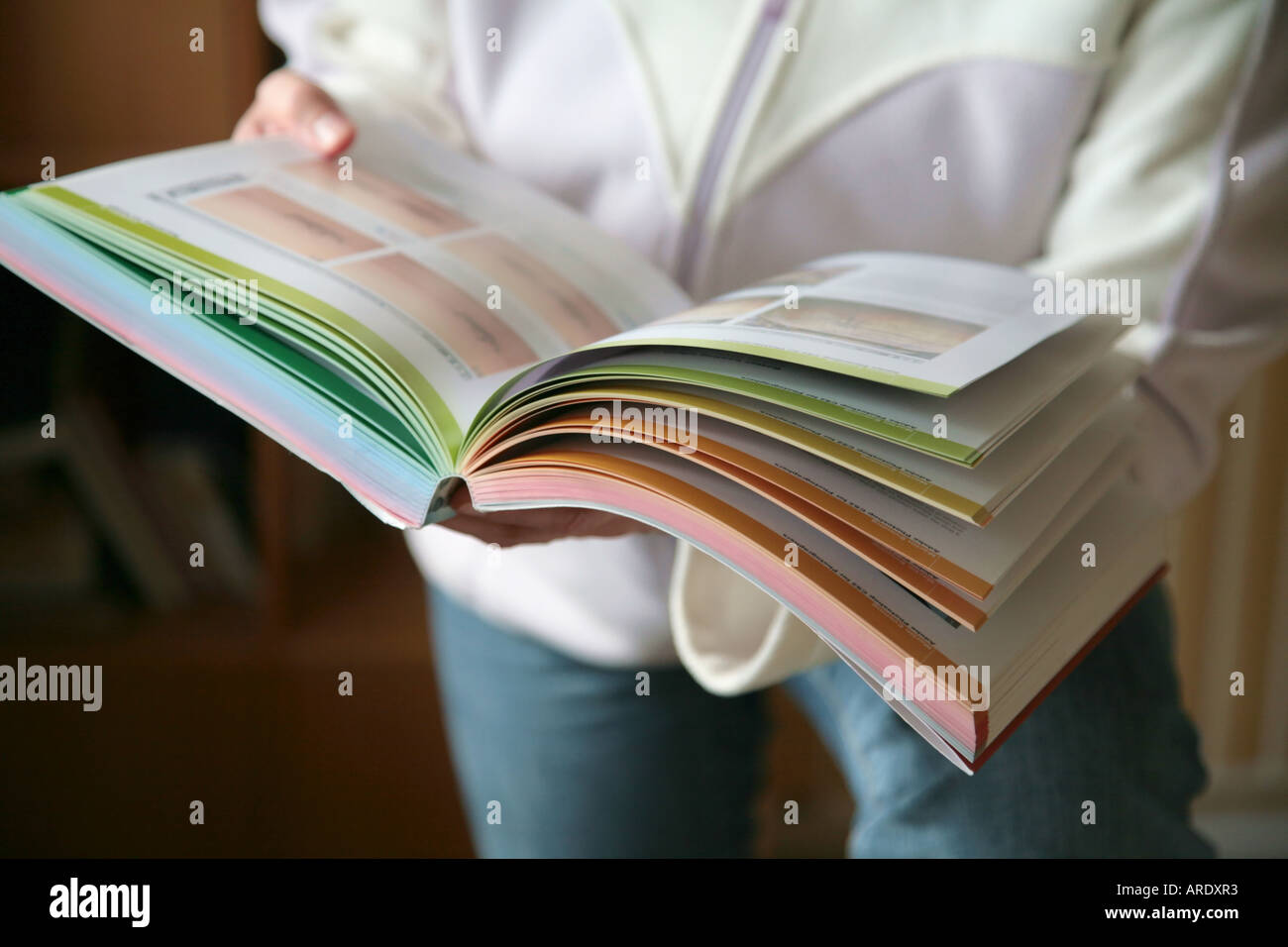 woman checking text book Stock Photo - Alamy