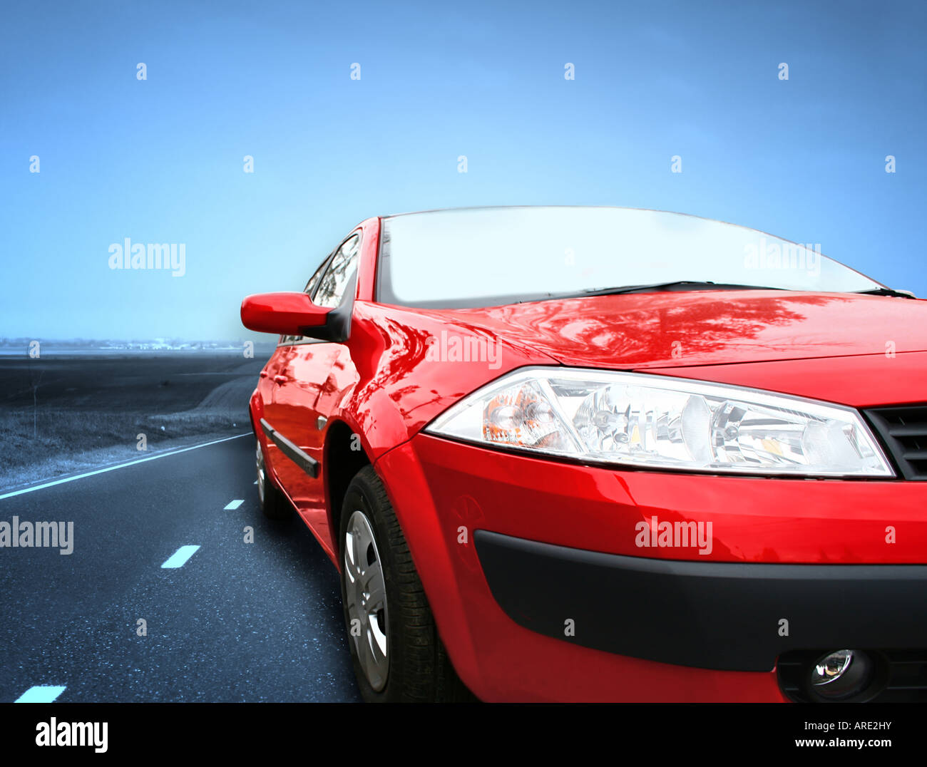 Beautiful red car on the road Stock Photo - Alamy