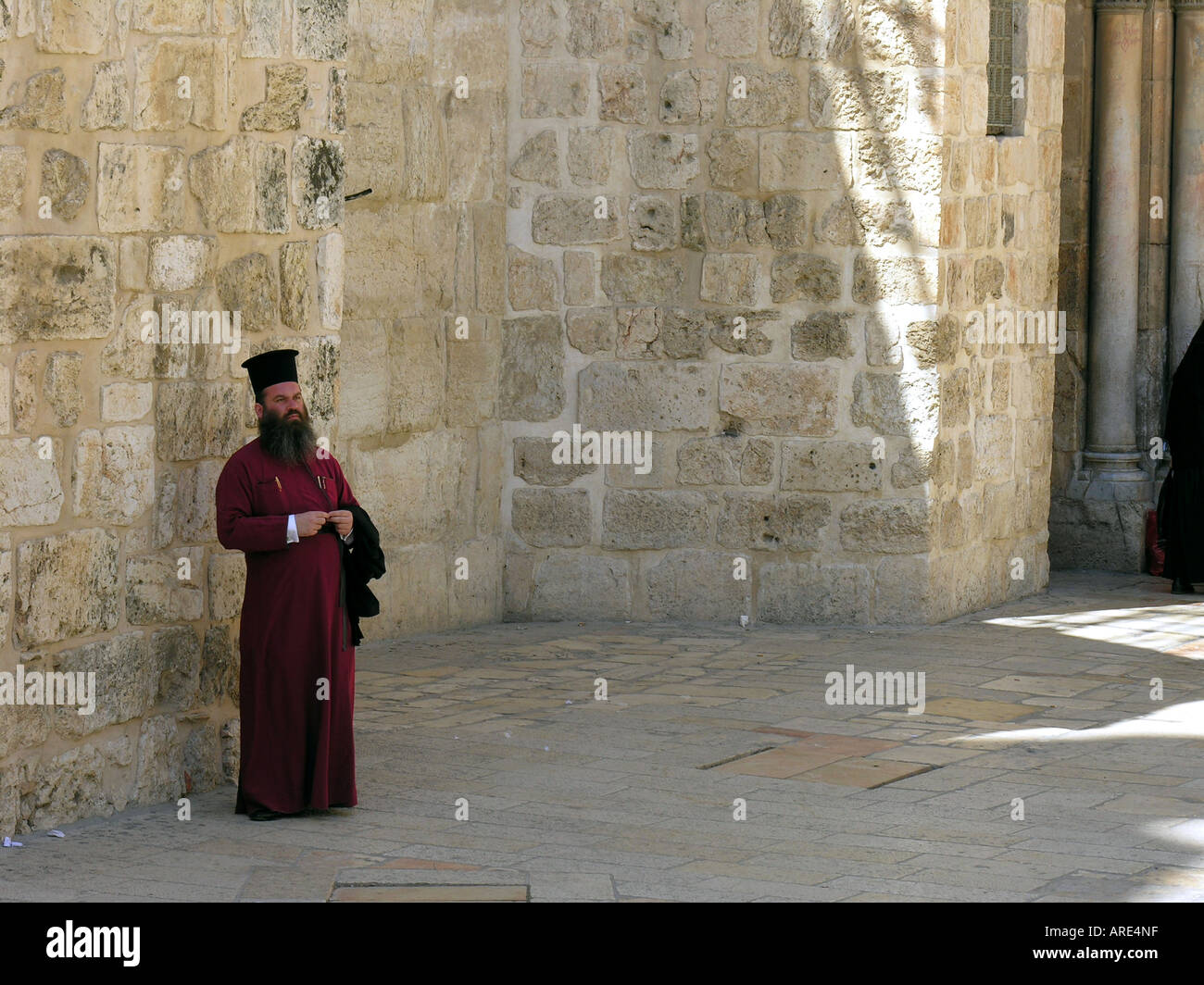 An orthodox priest paces outside the Church of the Holy Sepulchre ...