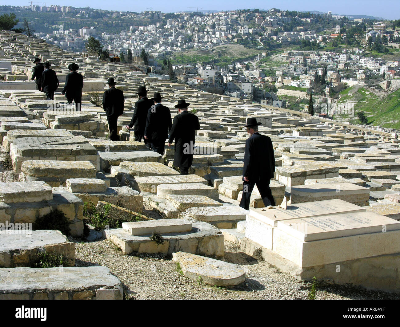 Visitors to the vast Jewish cemetery on the Mount of Olives with views ...