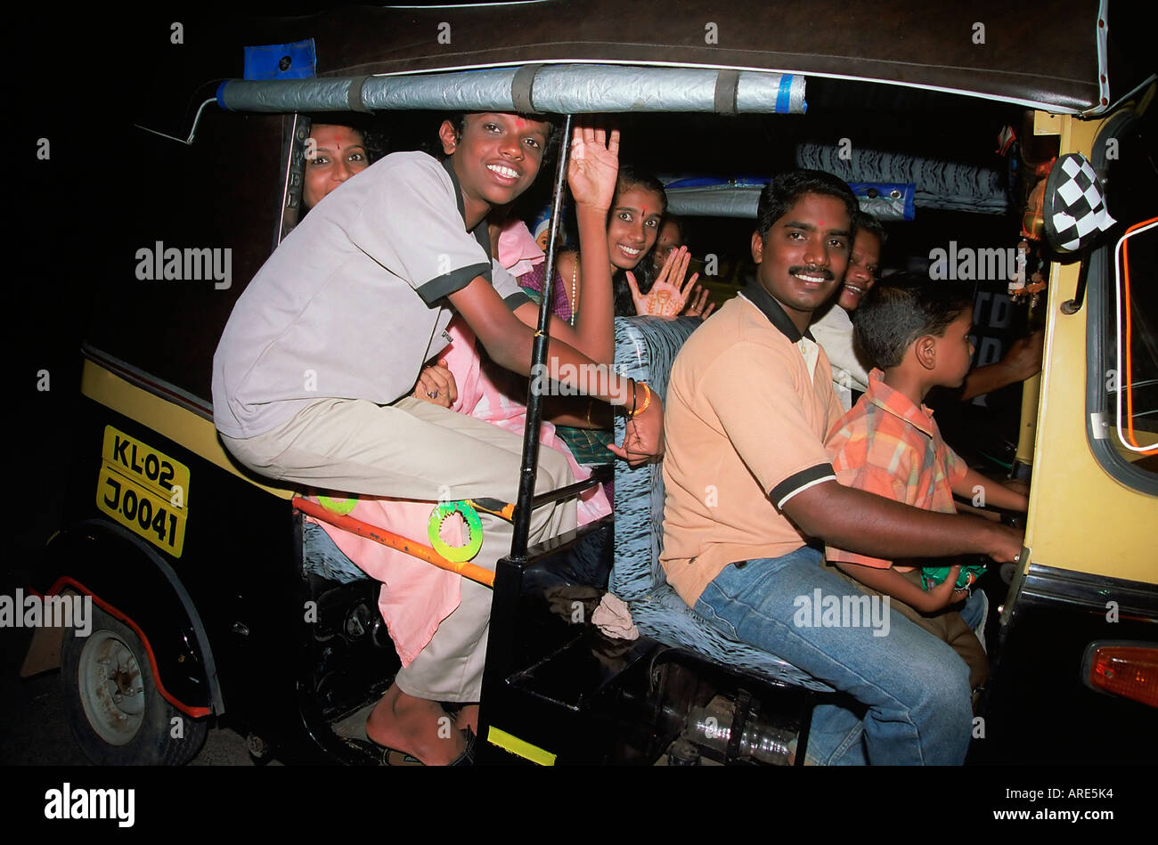 A happy overcrowded family in an auto rickshaws India Kerala a state on ...