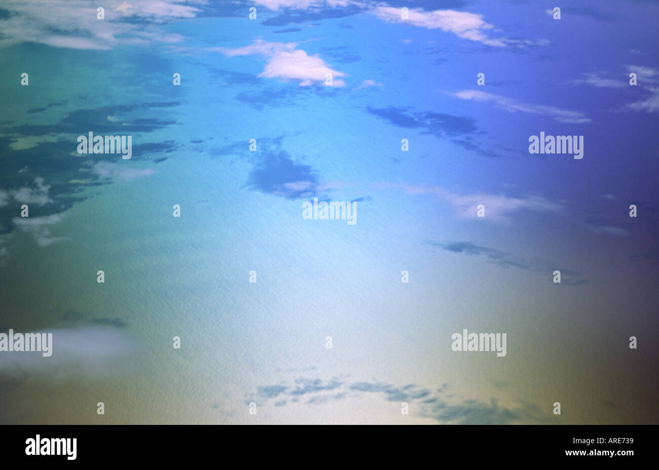 aerial view of calm blue sea ocean texture surface with clouds, shadows ...
