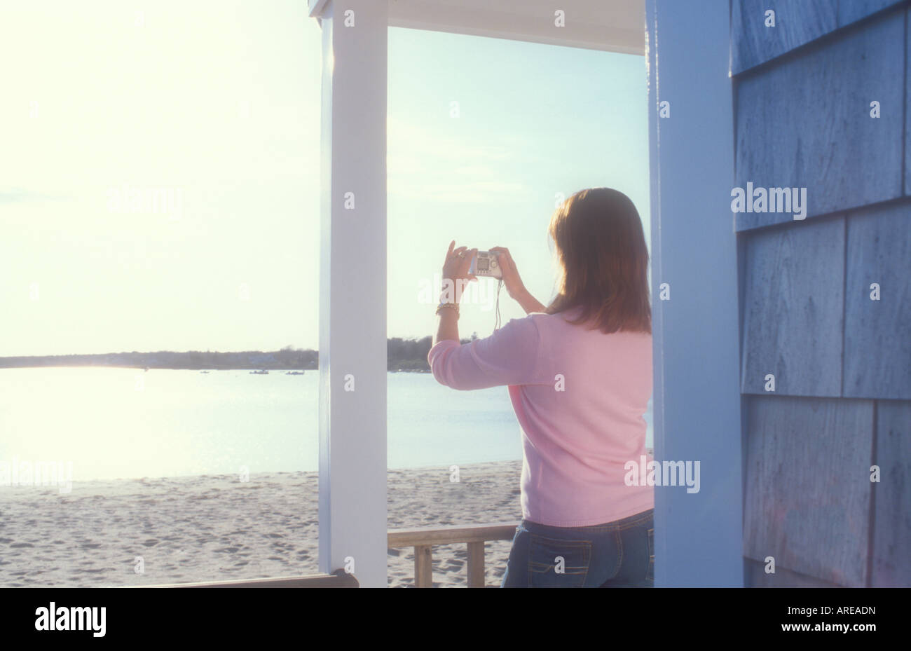 woman taking snapshot from porch her beach house Stock Photo - Alamy