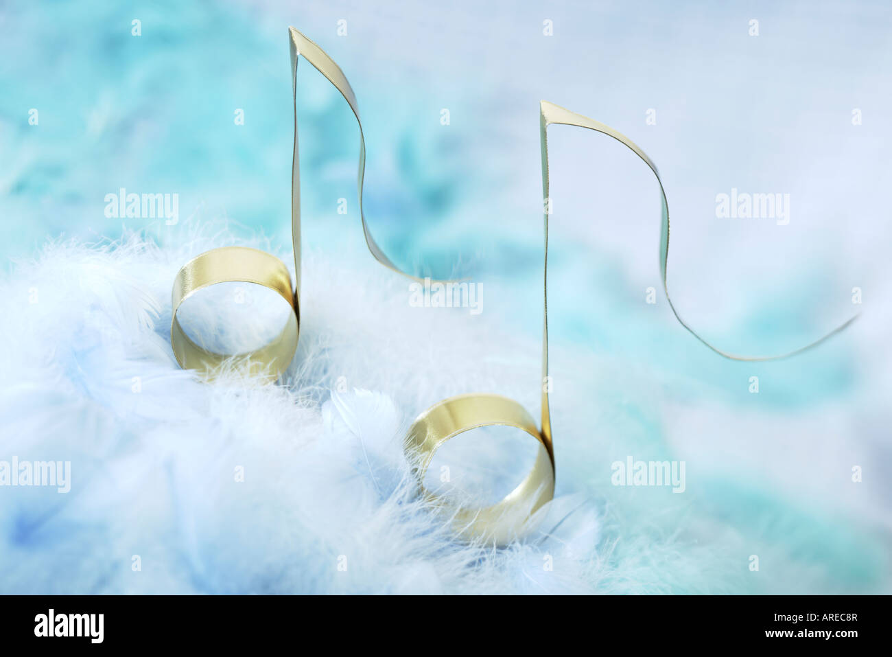 two golden quavers dancing in blue feathers Stock Photo - Alamy