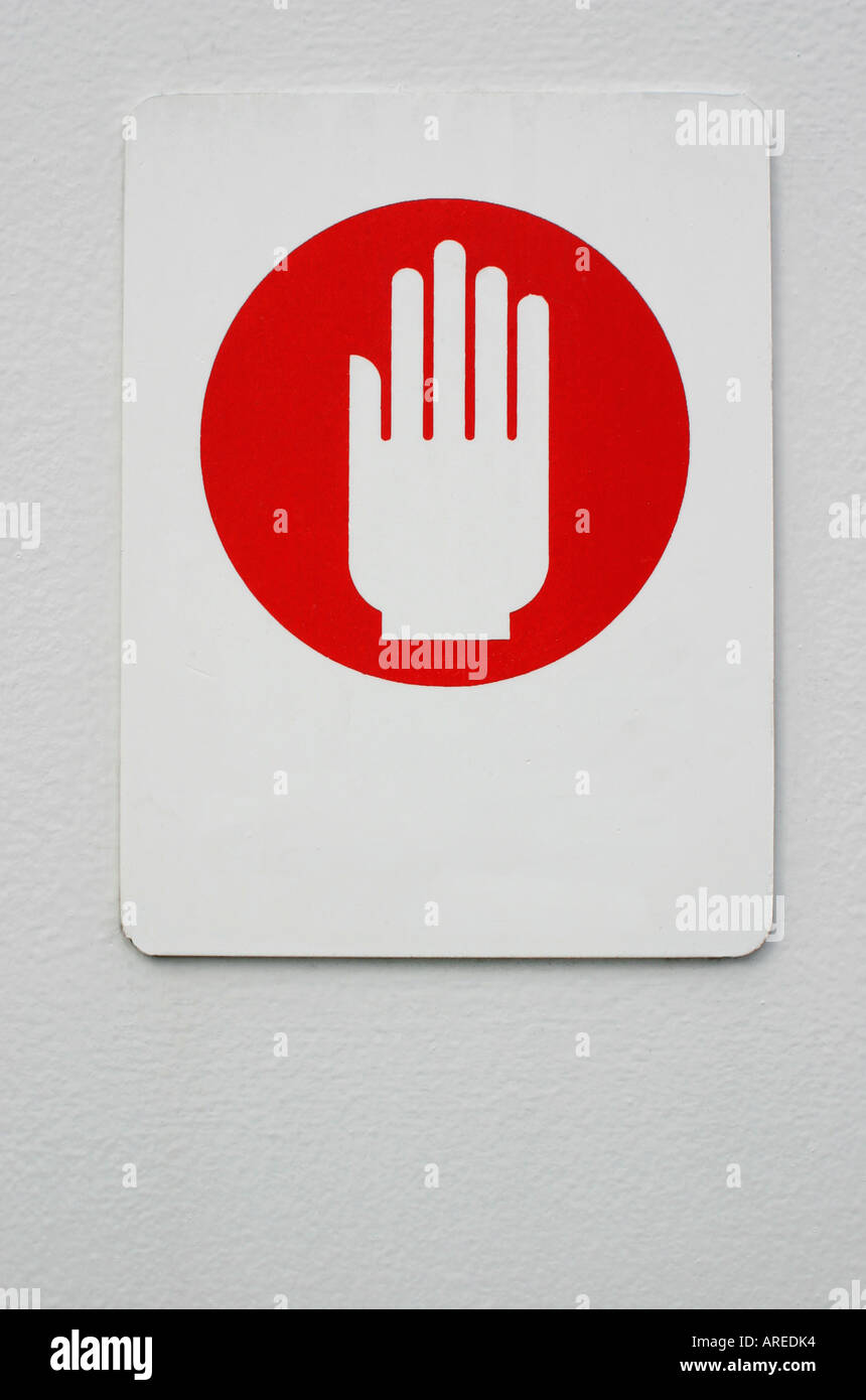 Caution or warning sign with a hand inside a red circle indicating halt ...
