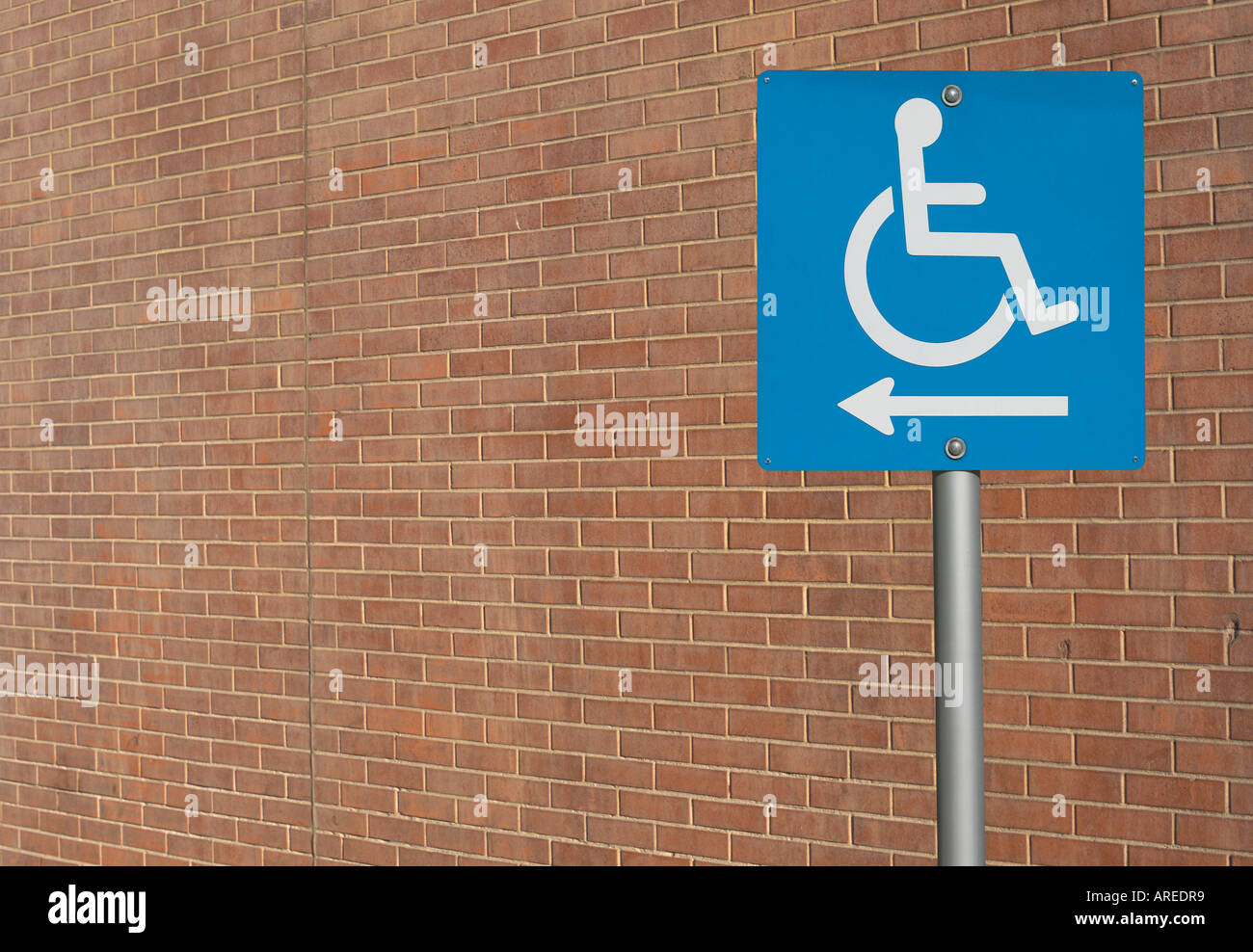 Disabled, handicapped or wheelchair sign with an arrow pointing left ...