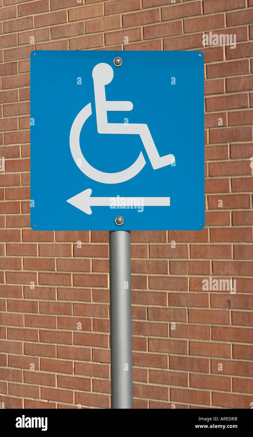 Disabled, handicapped or wheelchair sign with an arrow pointing left ...