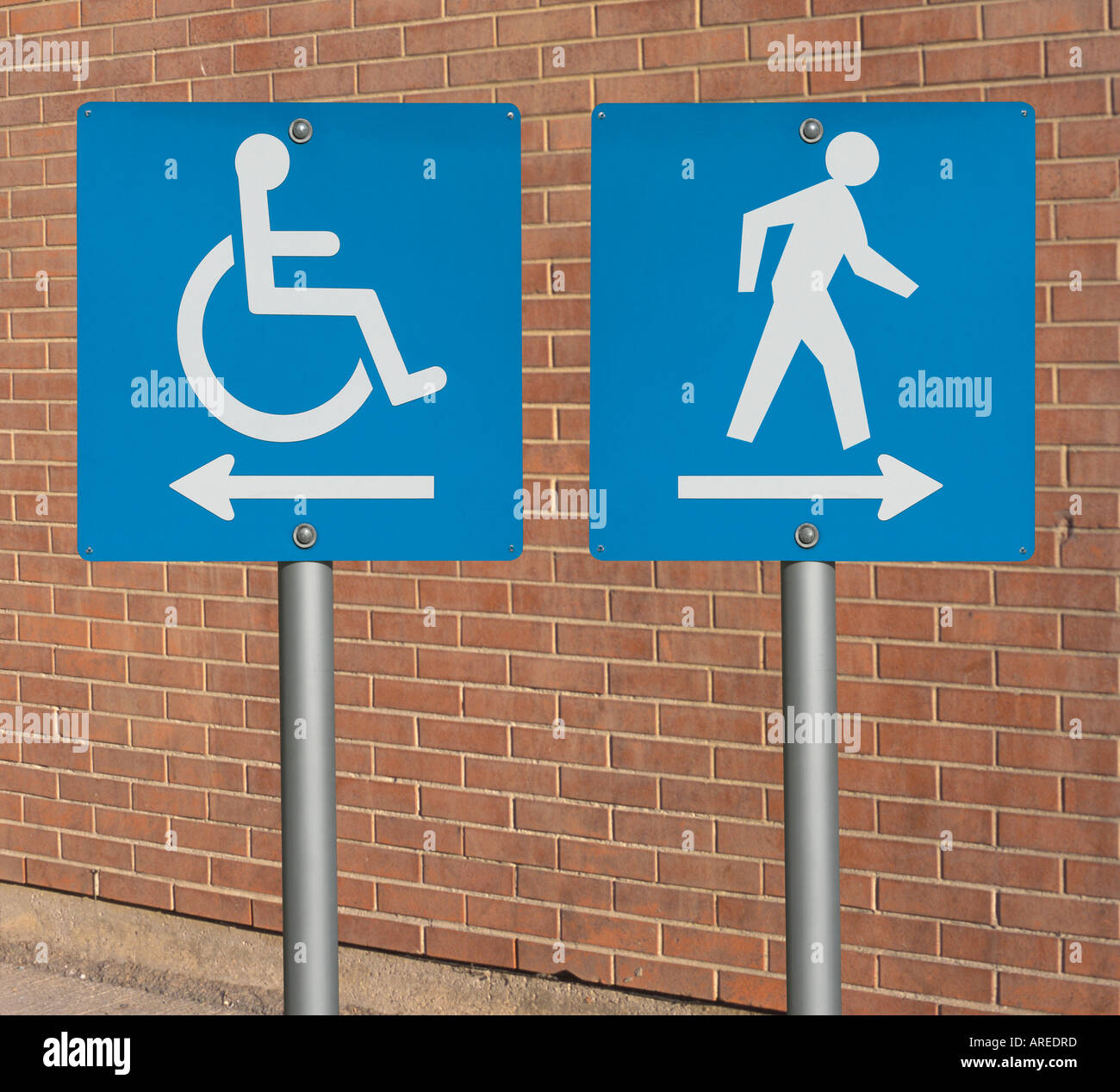 Wheelchair sign with arrow pointing left beside sign with a person ...