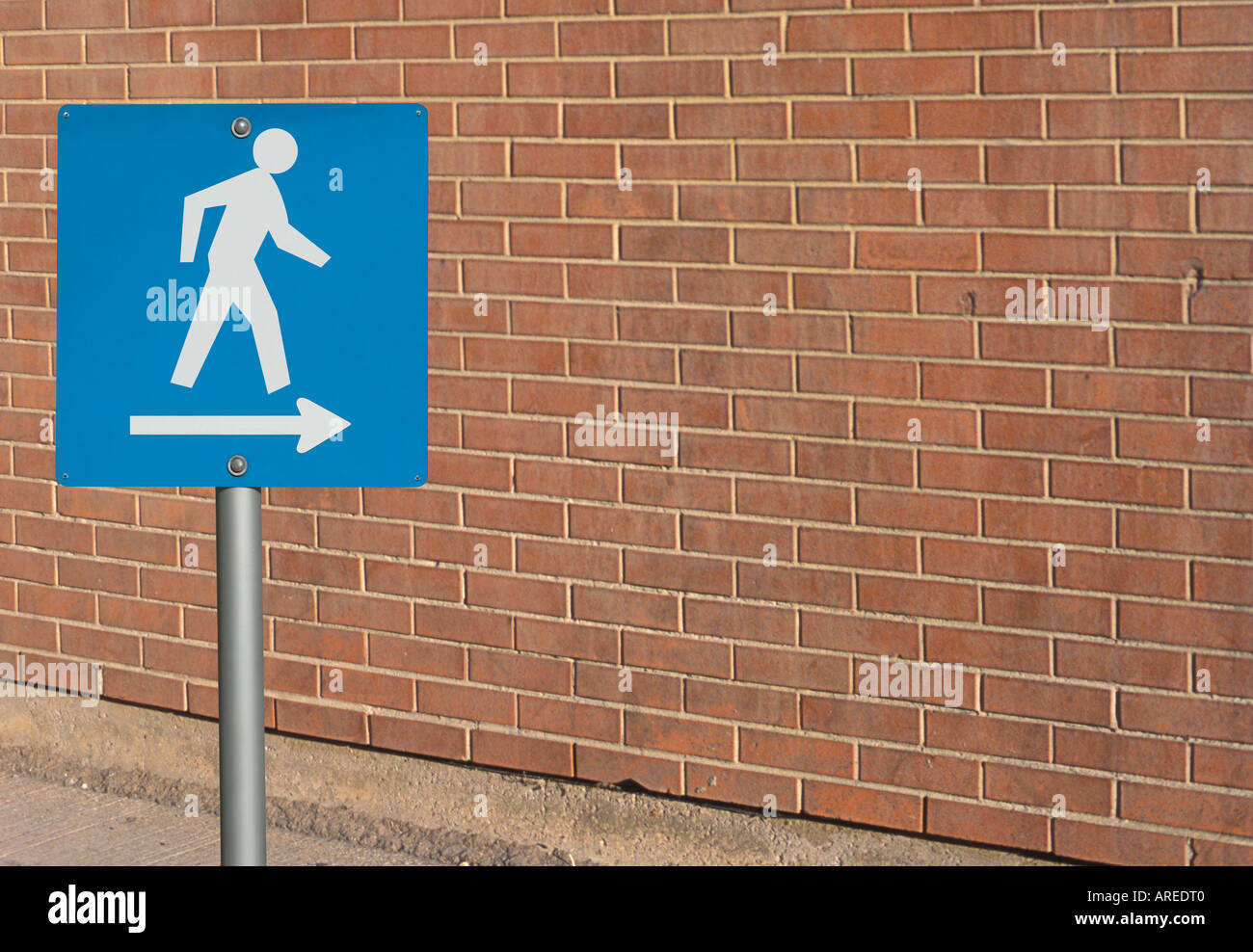 Sign showing a person or pedestrian walking above an arrow pointing ...