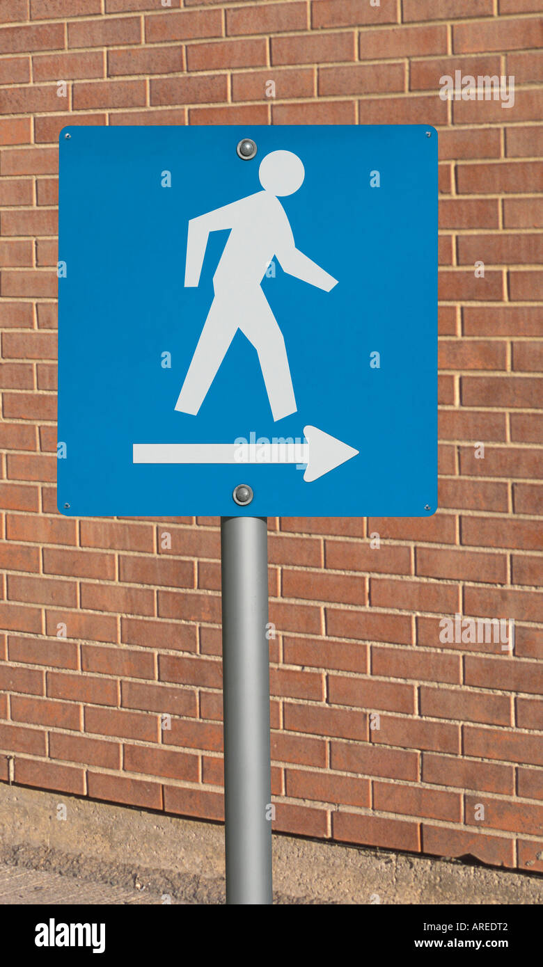 Sign showing a person walking above an arrow pointing left Stock Photo ...