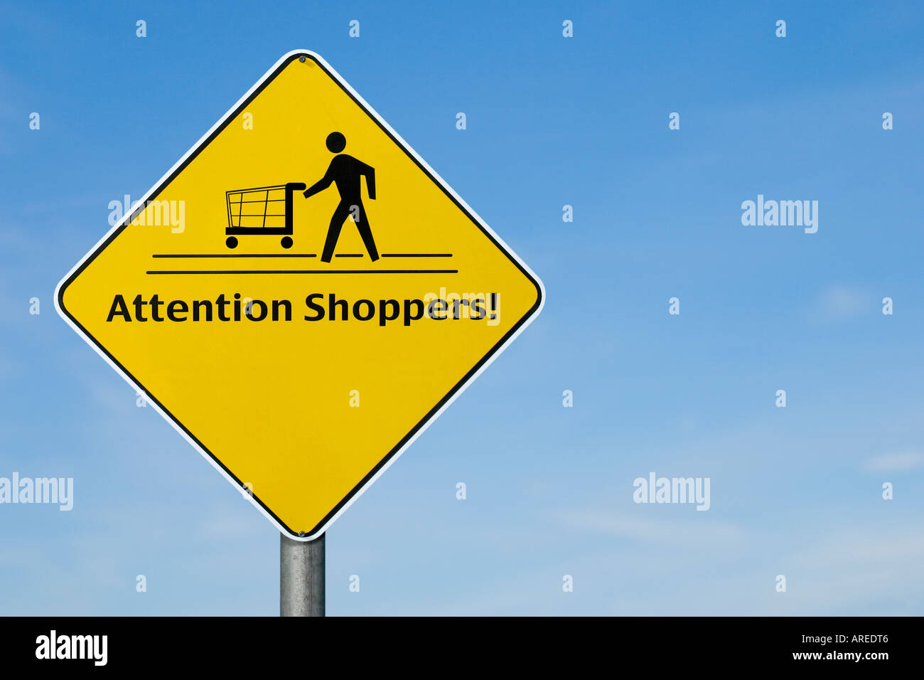 Attention Shoppers! sign with graphic of a person pushing a shopping ...