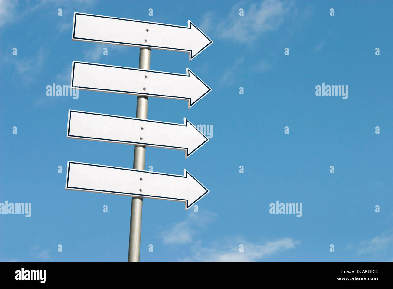 Sign with four blank white directional arrows pointing right Stock ...