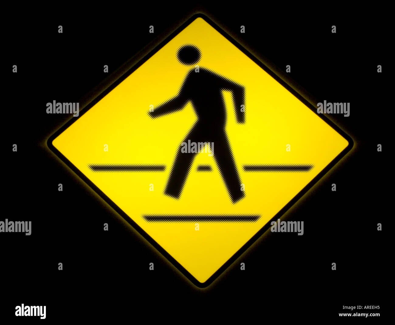 Illuminated yellow diamond shaped pedestrian crossing or walkway sign ...