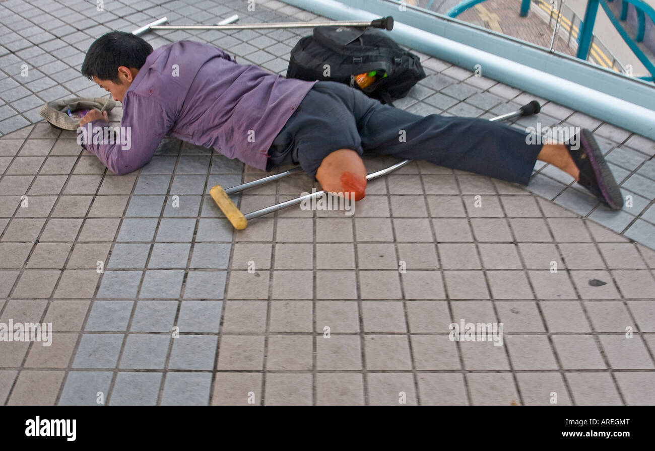 Crippled man begging Stock Photo - Alamy