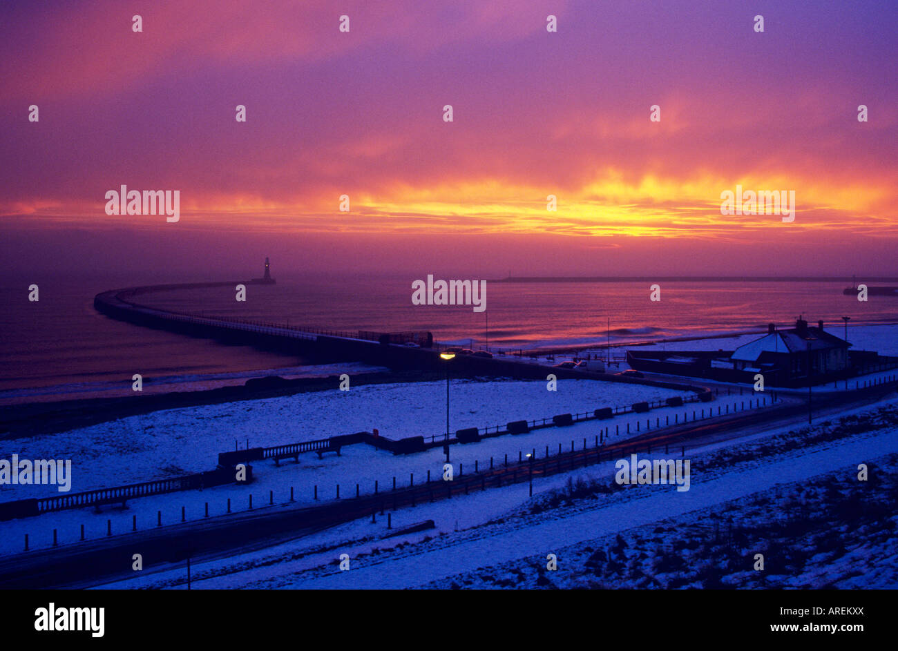sunrise over the ocean and snow covered Roker seafront & Pier in the ...