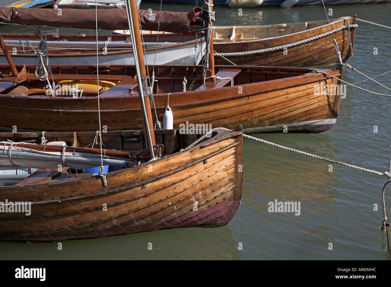A line of classic wooden sailing boat hulls River Deben Woodbridge ...