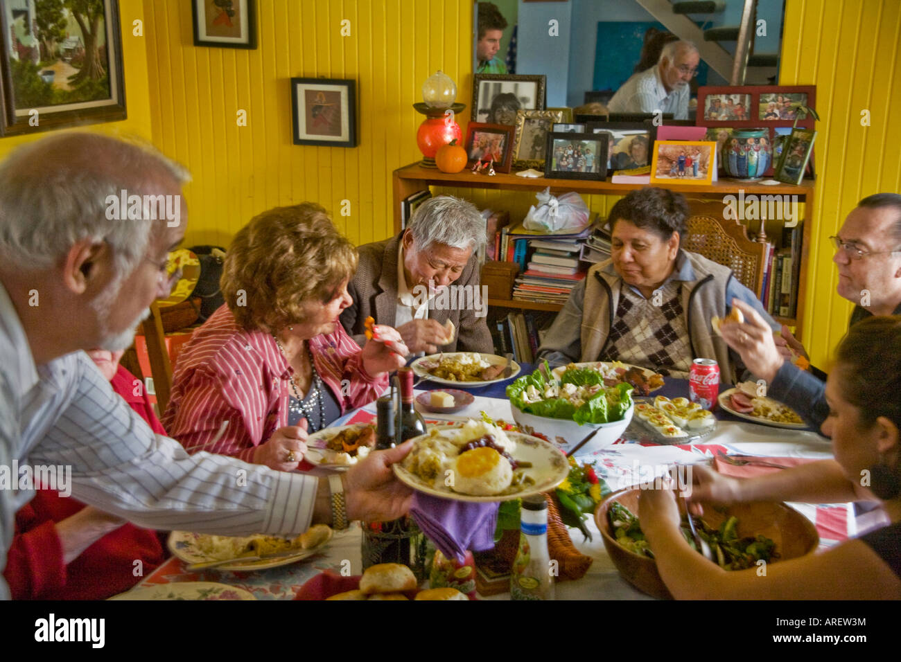 Family members of many ethnicities eat Thanksgiving dinner in ...