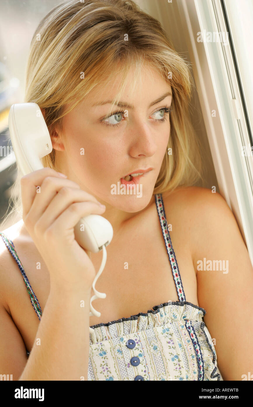 Girl looking anxious on phone Stock Photo - Alamy