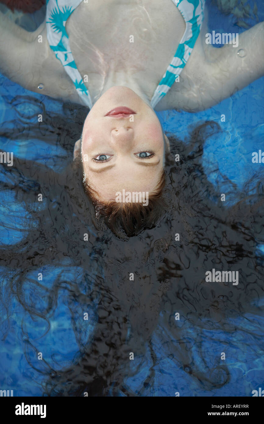 Portrait of a woman floating in a pool Stock Photo - Alamy