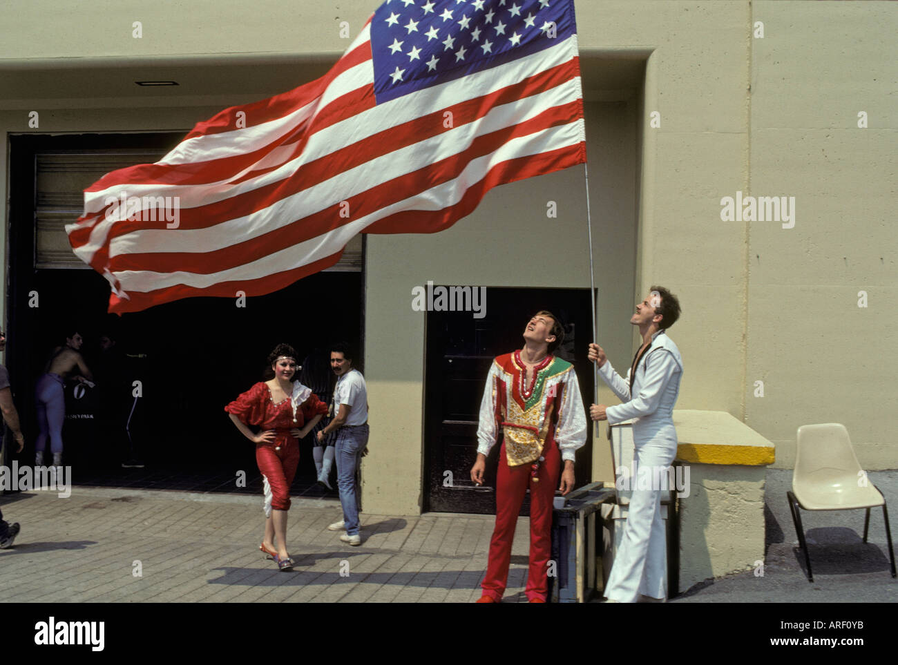 circus performers back stage w large american flag Stock Photo - Alamy
