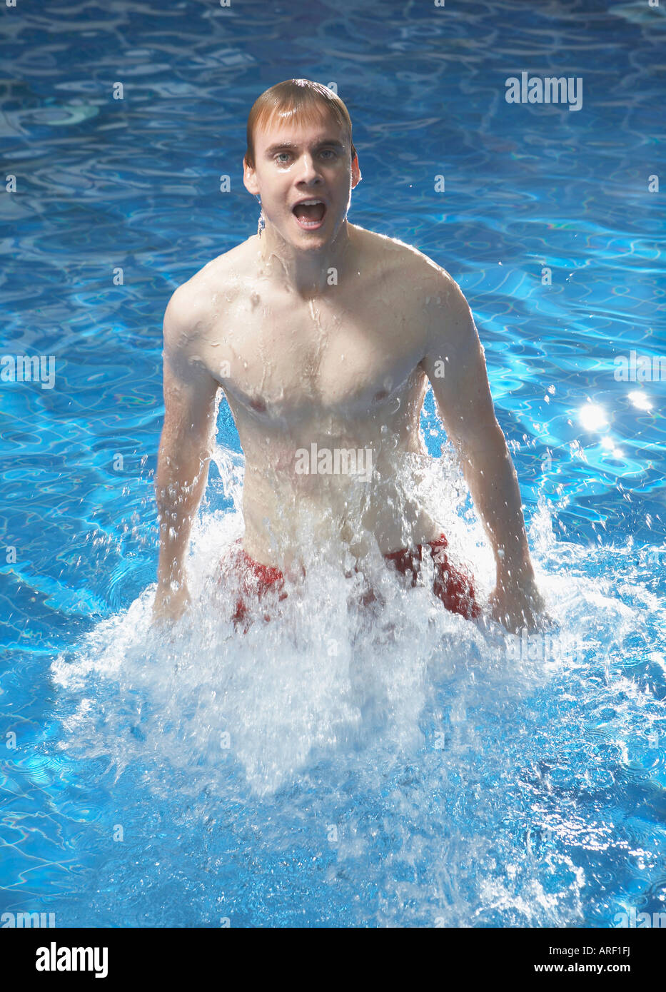 Man jumping up out of pool Stock Photo - Alamy