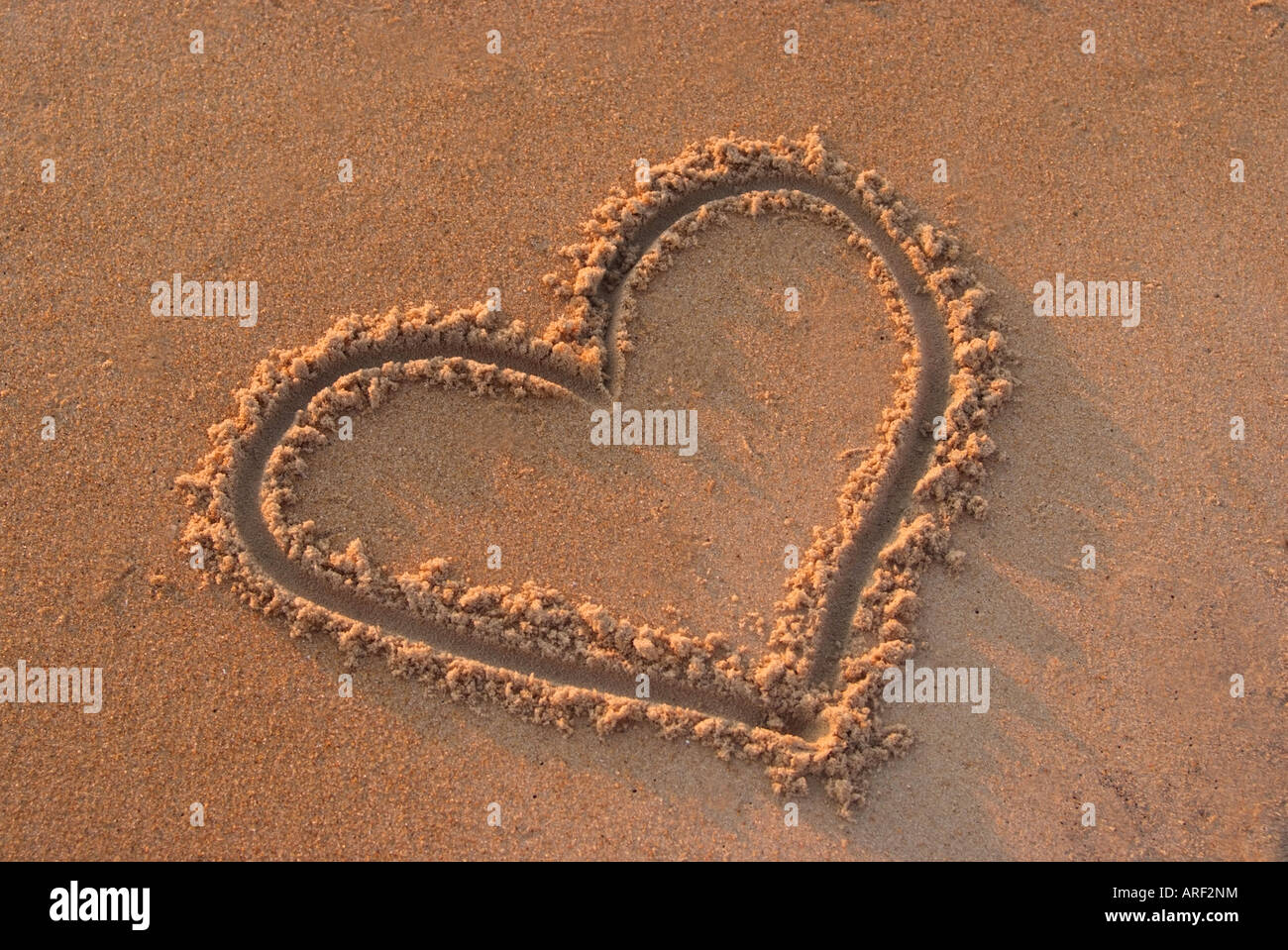Heart drawn in sand Stock Photo - Alamy