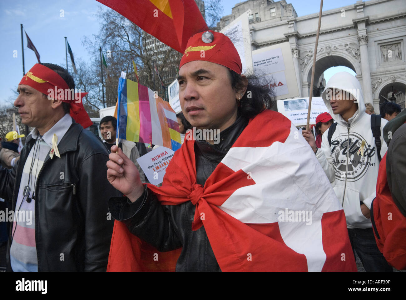 Burmese man wearing Freedom flag and red fighting peacock hat with ...