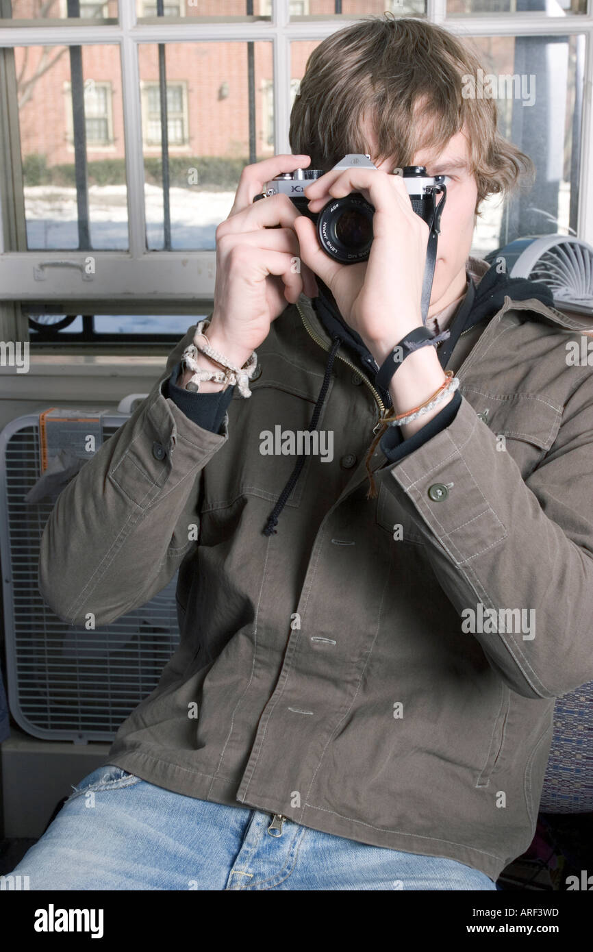 Young man looking through camera Stock Photo - Alamy