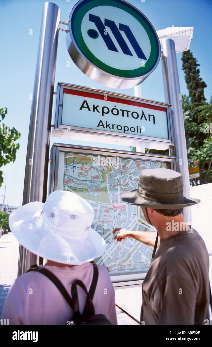 Tourists checking map at entrance of Acropolis Metro station central ...
