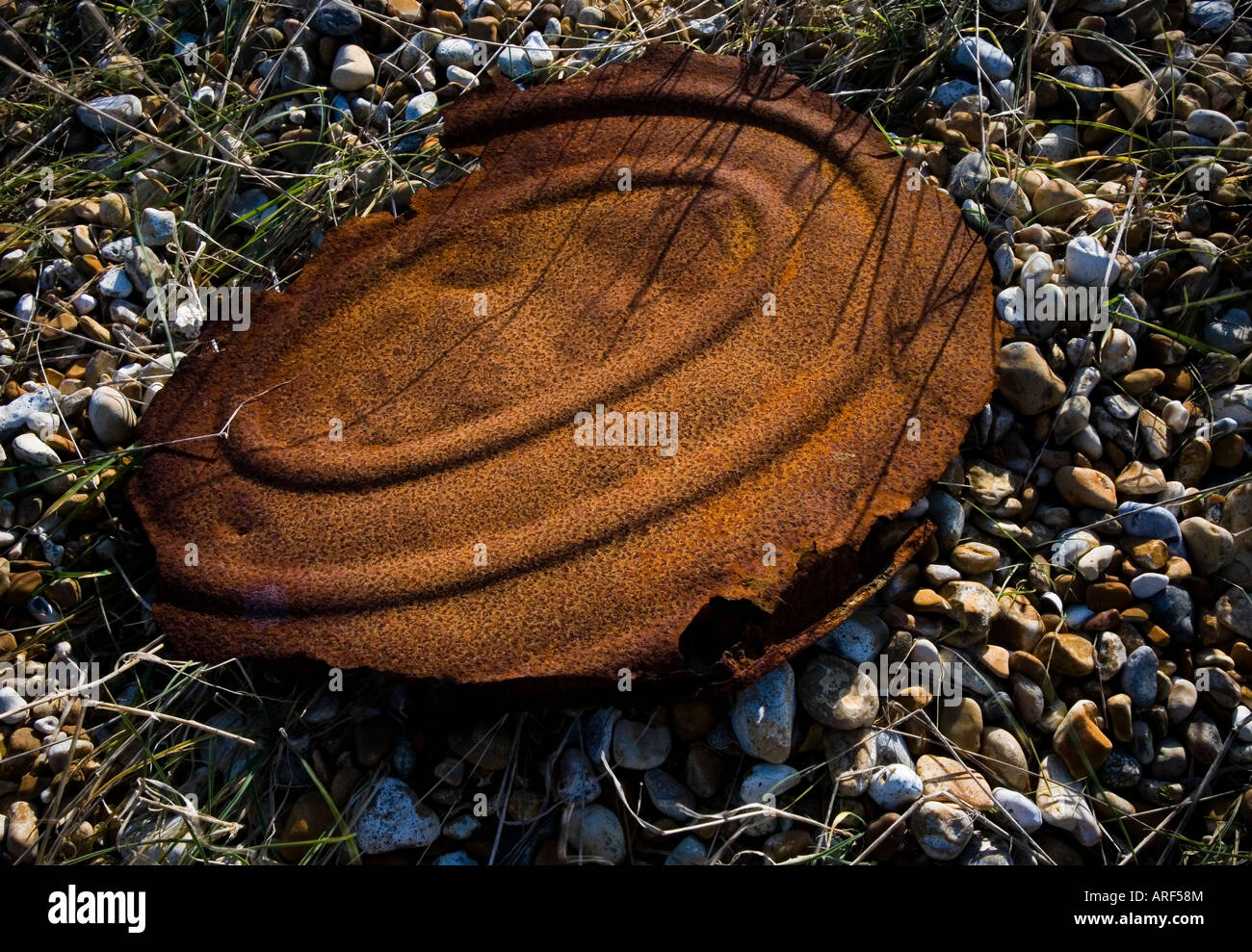 Rusted metal sheet on shingle beach Stock Photo - Alamy