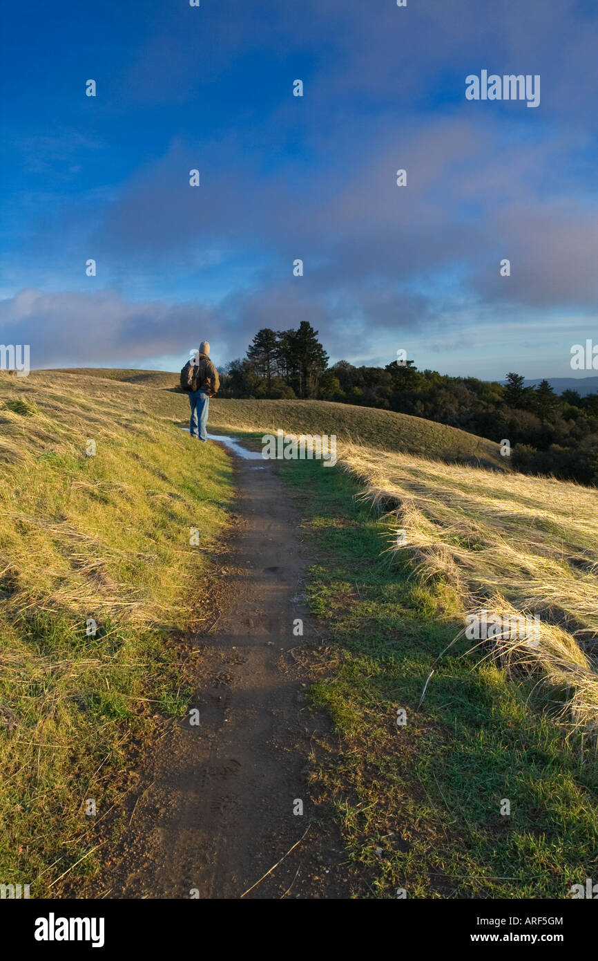 Hiker walking the trails and enjoying the views of Russian Ridge Open ...