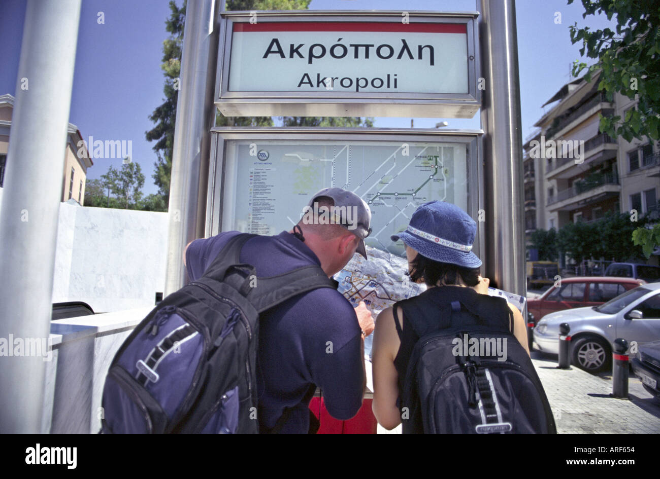 Tourists checking map at Acropolis Metro Station central Athens Greece ...