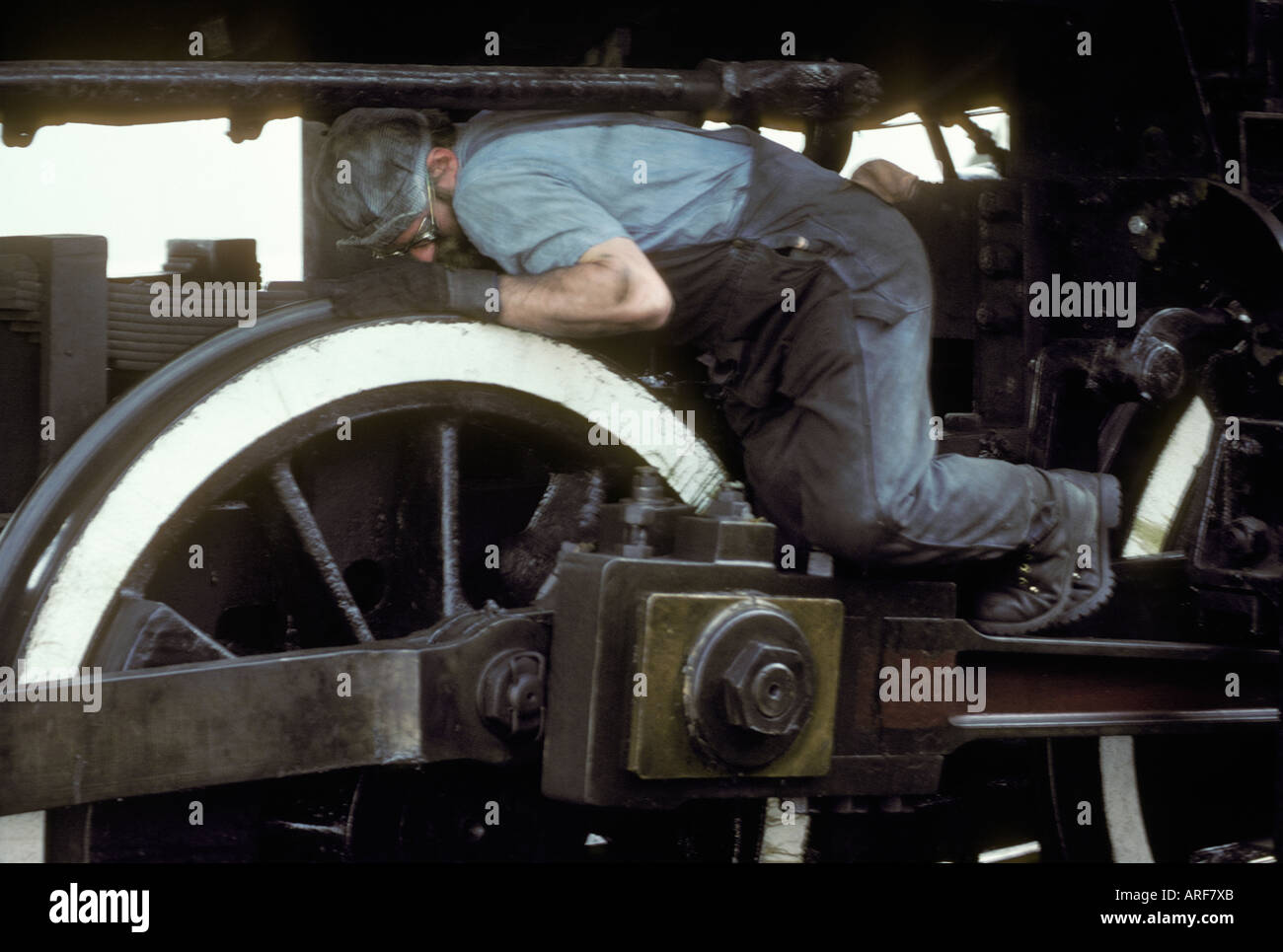 engineer brakeman checks engine wheels brakes on steam locomotive Stock ...
