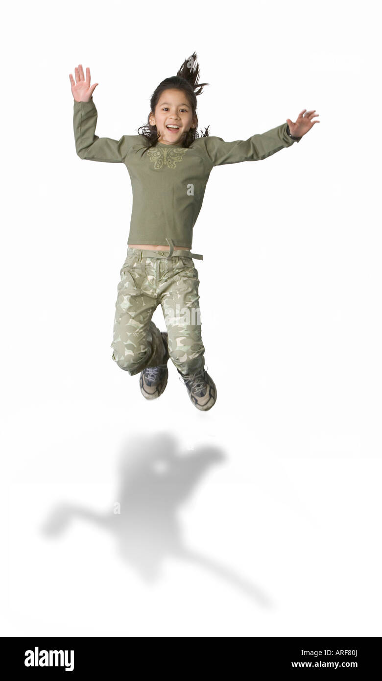 Pre teen Latino girl jumping for joy Stock Photo - Alamy