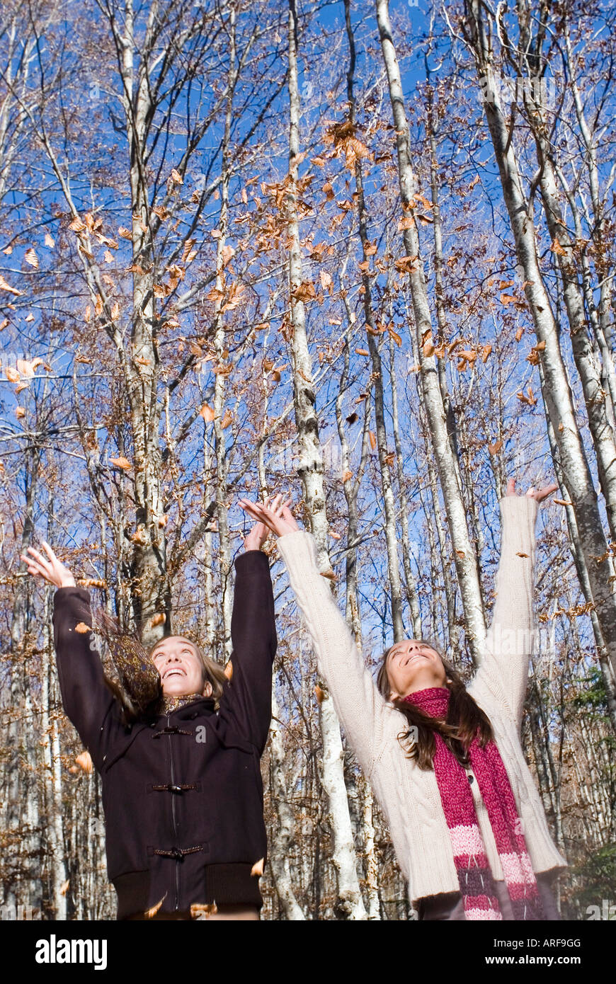 2 young woman throwing leaf in the air Stock Photo - Alamy