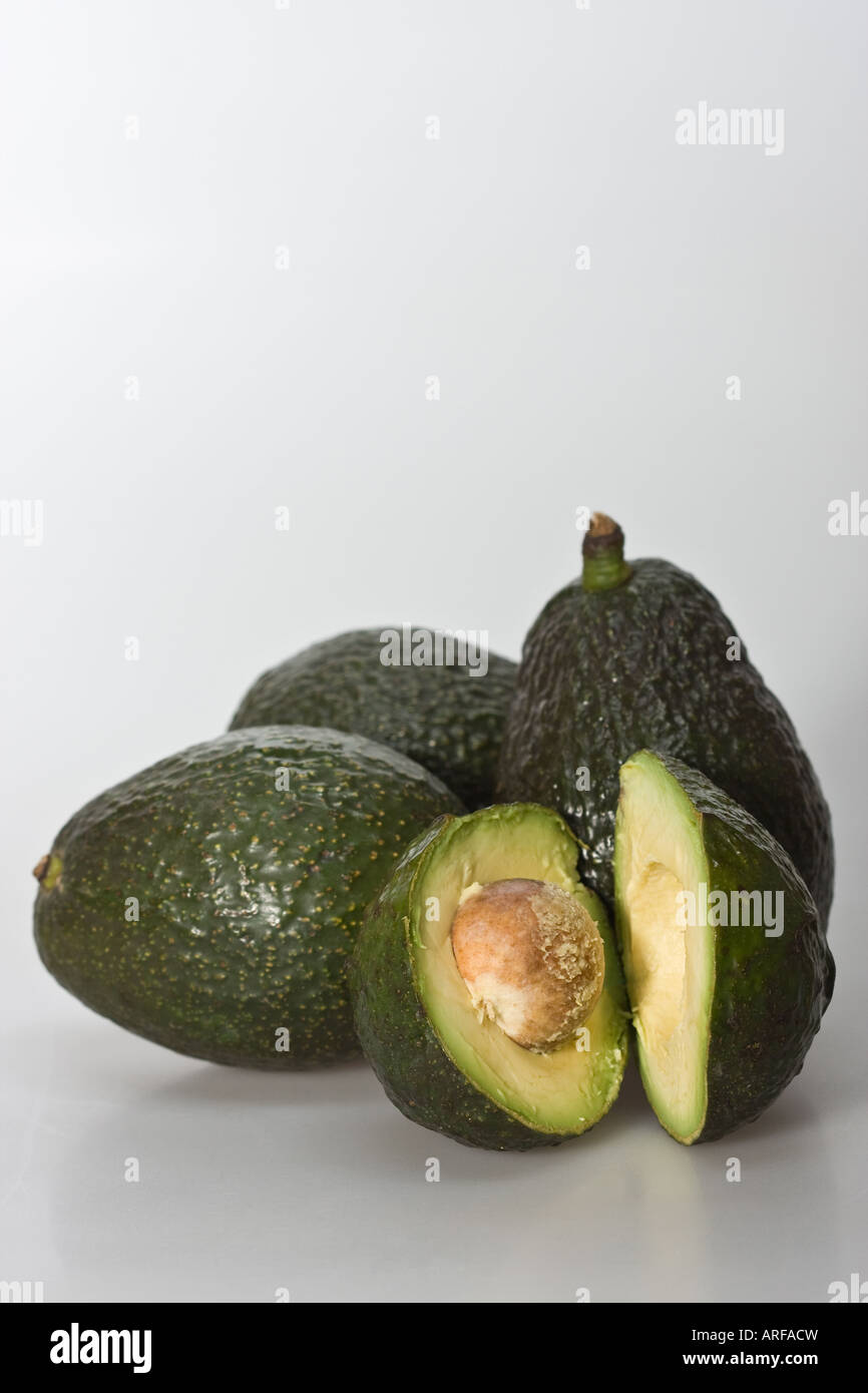 Close up of whole a Avocados pears sead half fruit from above on white ...