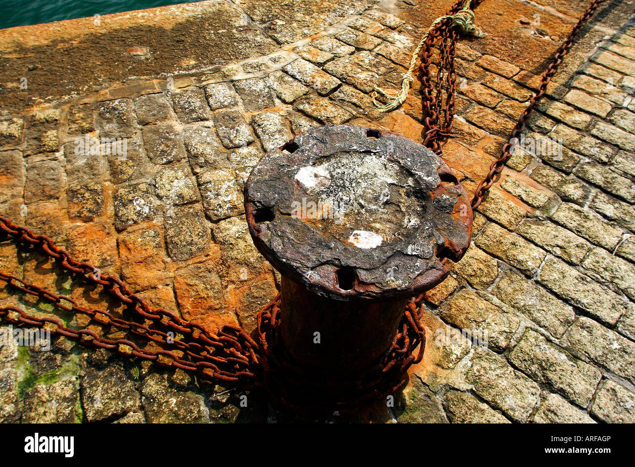 Europe England Cornwall chain wrapped around bollard on Mullion quay ...