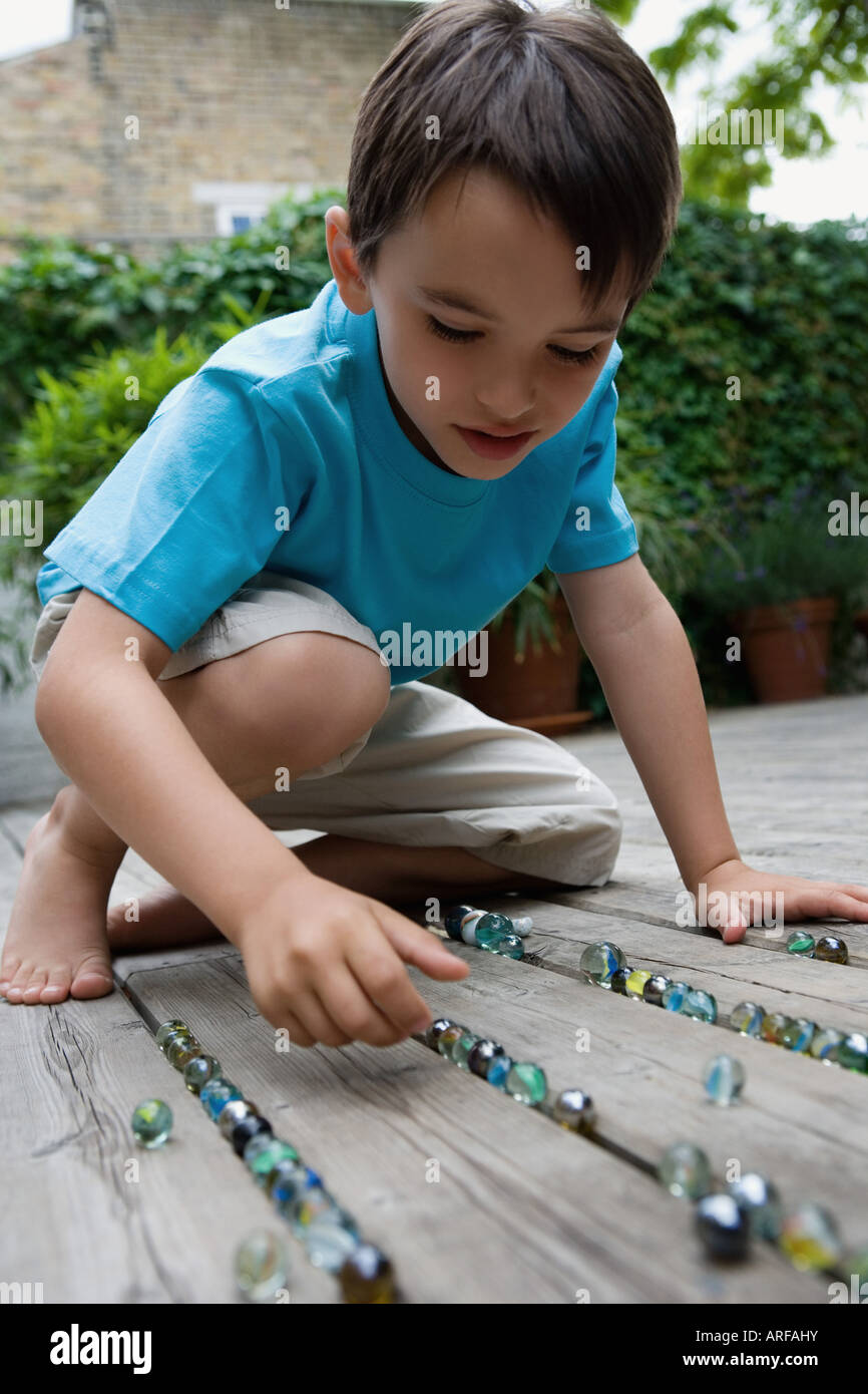 Boy playing marbles hi-res stock photography and images - Alamy